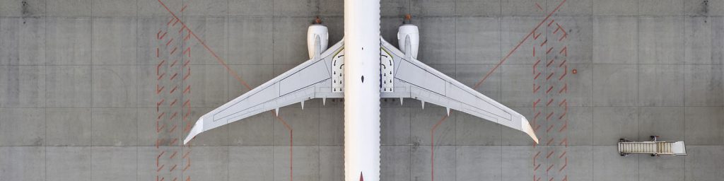 Top down view on comercial airplane docking in terminal in the parking ...