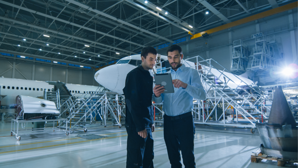 Aircraft Maintenance Worker and Engineer having Conversation. Holding ...